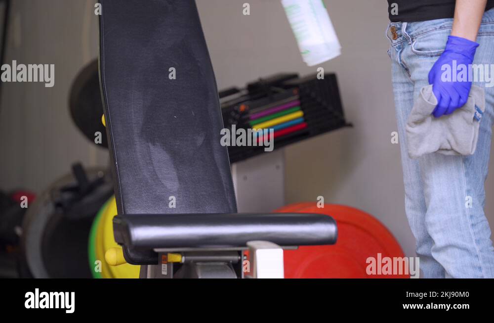 Woman cleaning and sanitizing a workout bench at a gym Stock Video ...