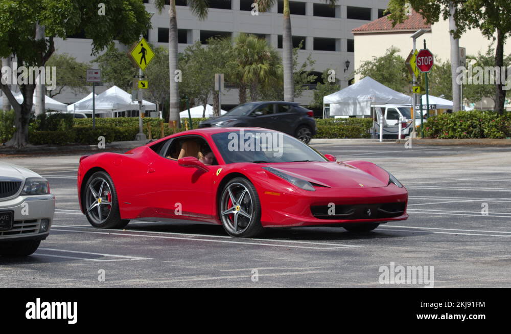 Couple sitting in a red ferrari Aventura Mall parking lot 6k shot on ...