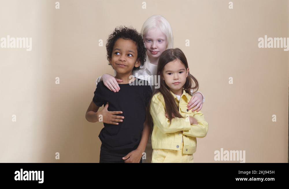Adorable kids of diverse nationalities and skin colors stand together ...
