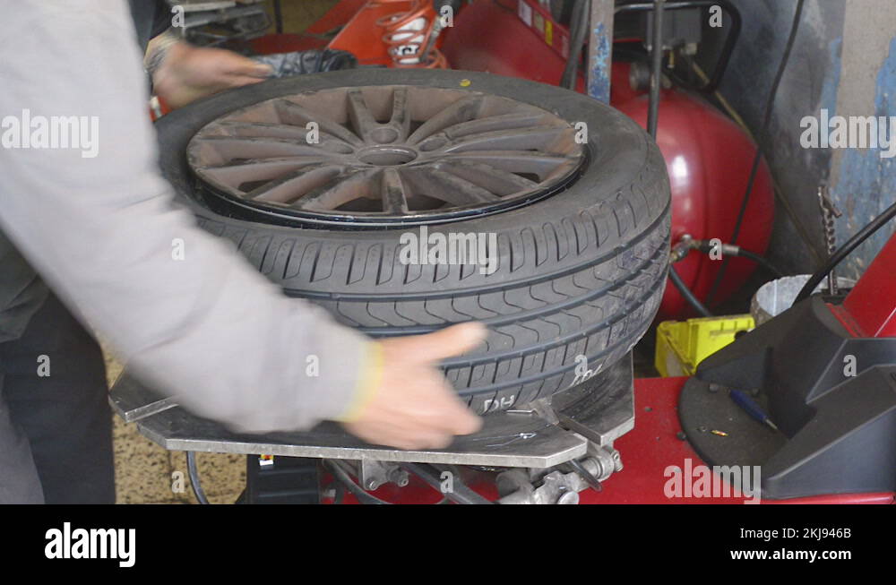 Tire mechanic changing a wheel in mechanical workshop Stock Video ...