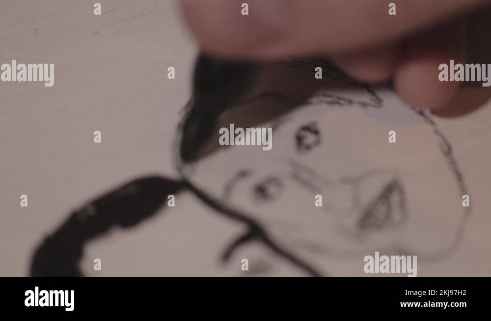 A Person Tracing The Pencil Sketch On The Paper Using A Black Marker ...