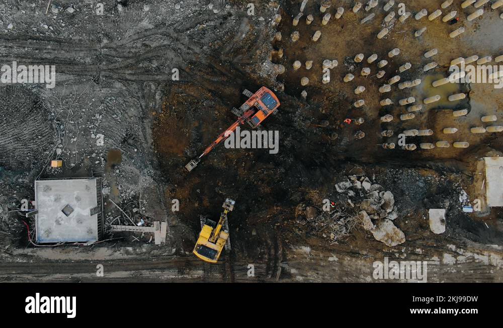 drone top view excavators digging pit for building foundation for a ...