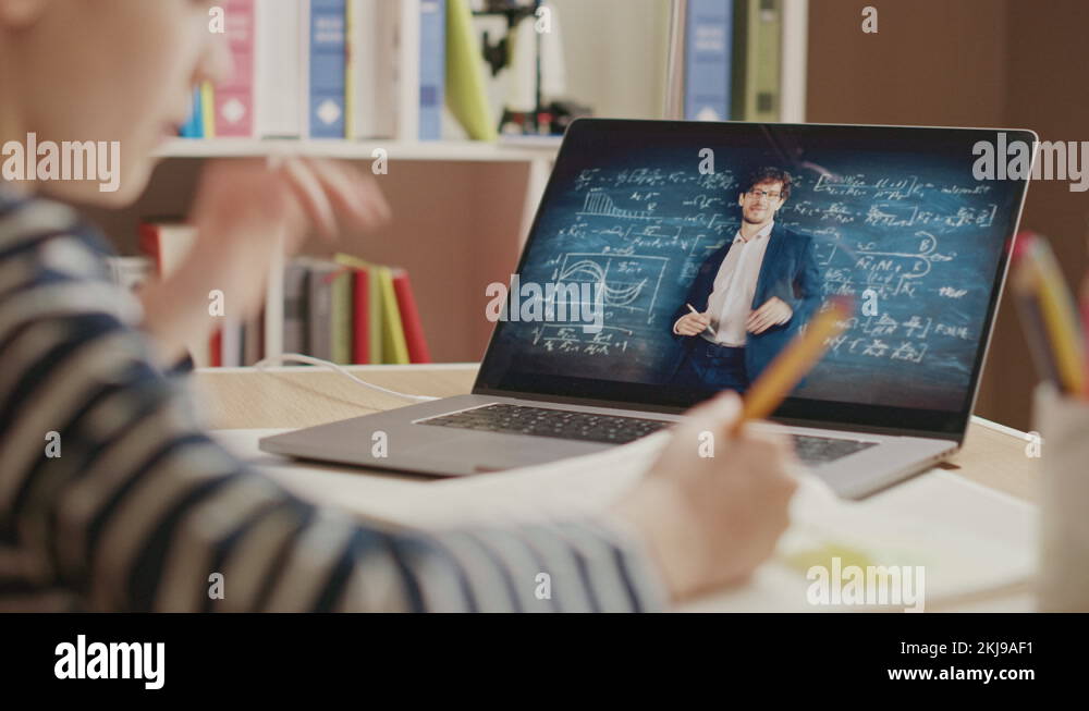 Little Boy Uses Laptop for Video Call with Teacher. Screen Shows Online ...