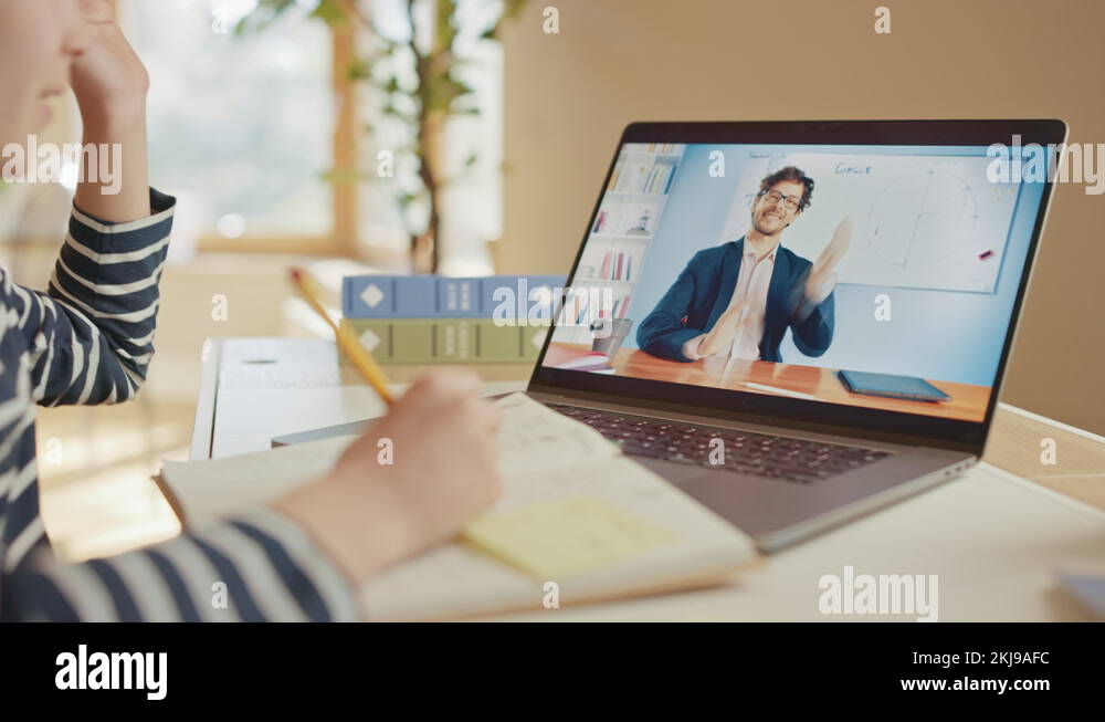 Smart Little Boy Uses Laptop for Video Call with Teacher. Screen Shows ...