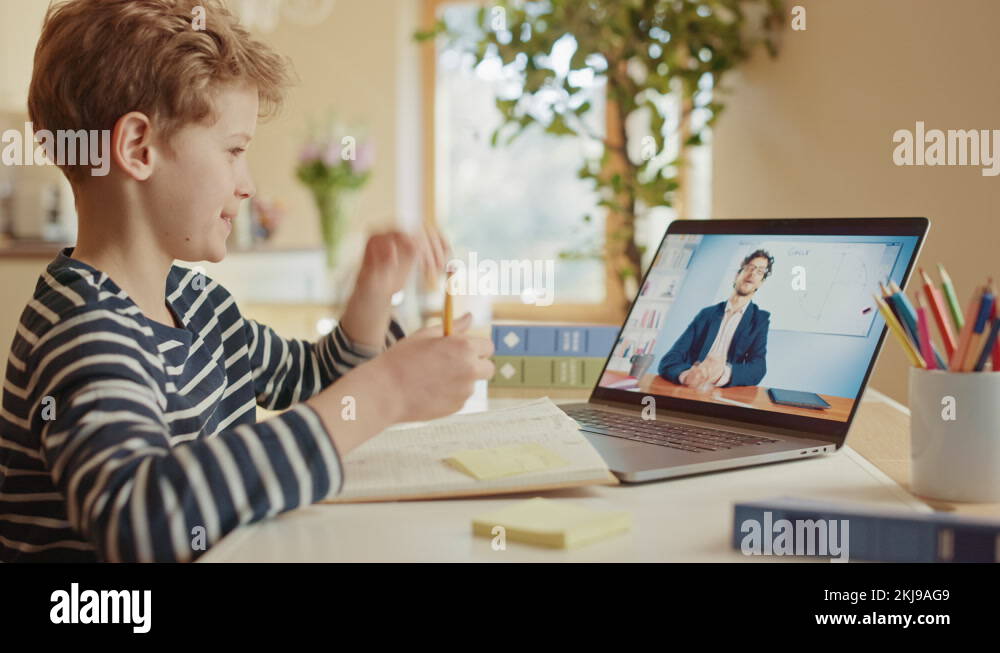 Smart Little Boy Uses Laptop for Video Call with Teacher. Screen Shows ...