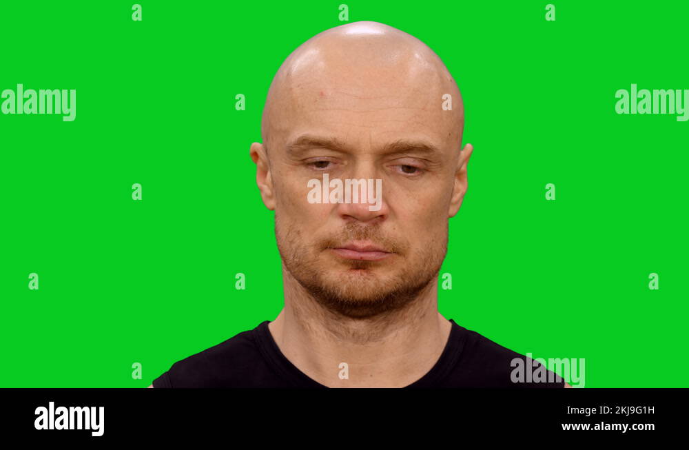 Close up of shocked man making stunned and surprised face on green ...