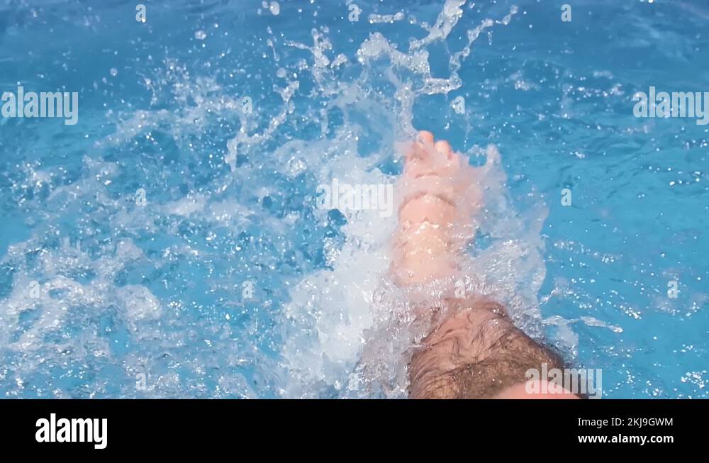 Man shake his legs into swimming pool. Slow motion Stock Video Footage ...