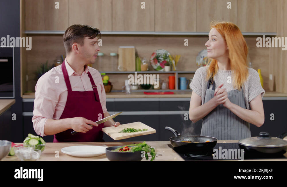 Cooking show hosts chefs, male and female, cooking in the kitchen ...