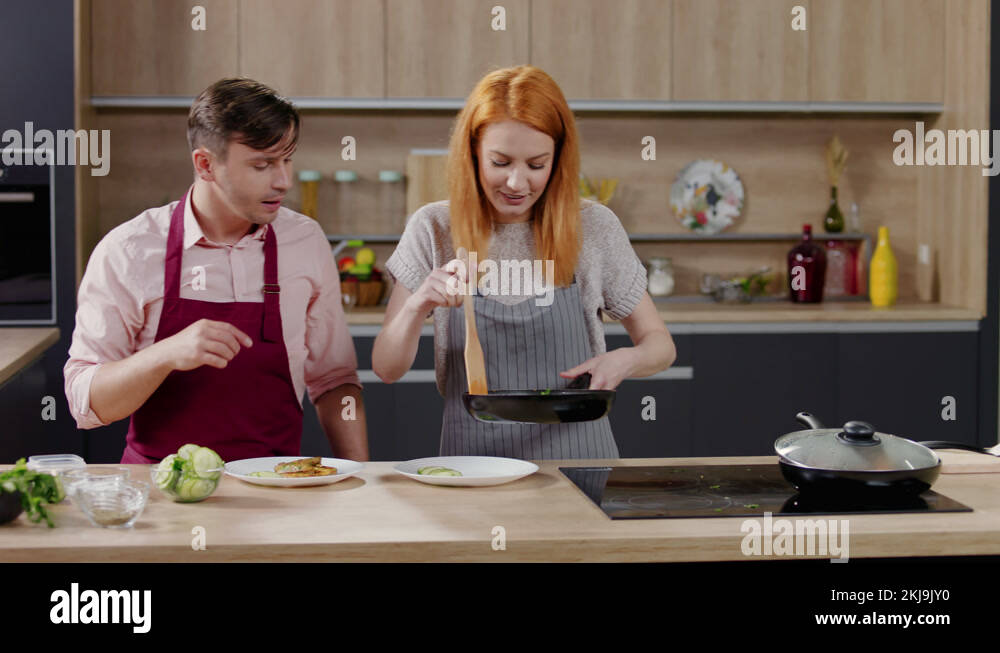Cooking show hosts chefs, male and female, cooking in the kitchen ...