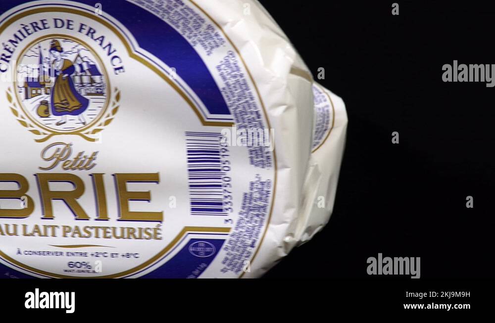Brie cheese is a famous French cheese. Dolly shooting on a black ...