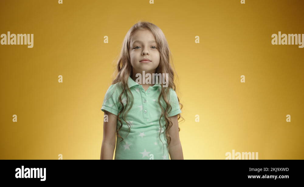 Little caucasian girl shruging and throwing her arms wide in ...