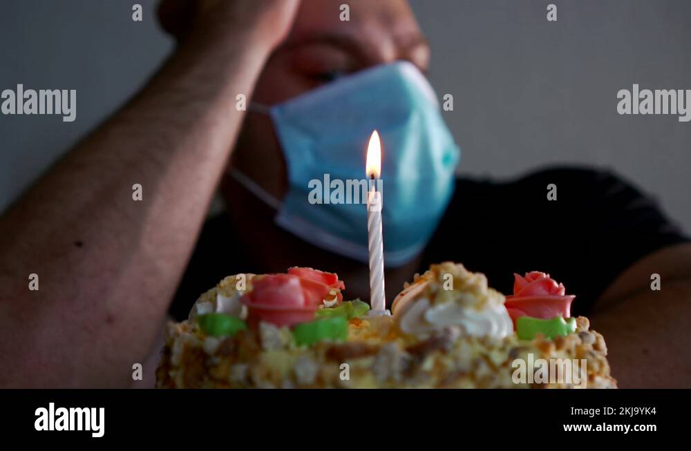 unhappy man is celebrating his birthday alone at self-isolation, cake ...