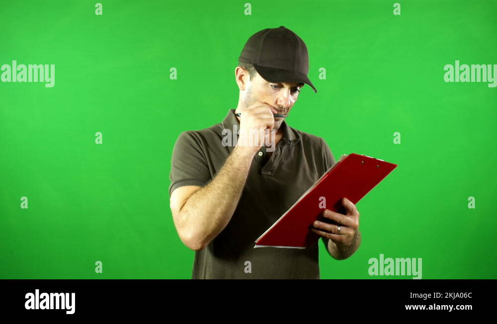 Courier / Delivery man writing on a Clipboard. Green screen Chroma key ...