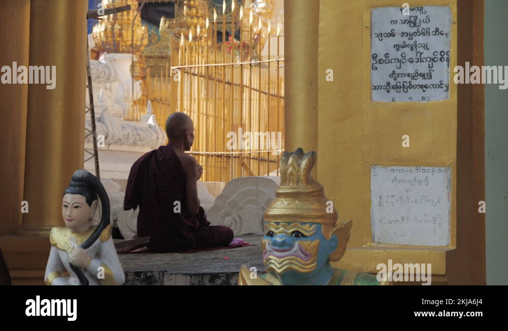 Static of Buddhist Monk Praying Alone In Shwedagon Temple In Yangon ...