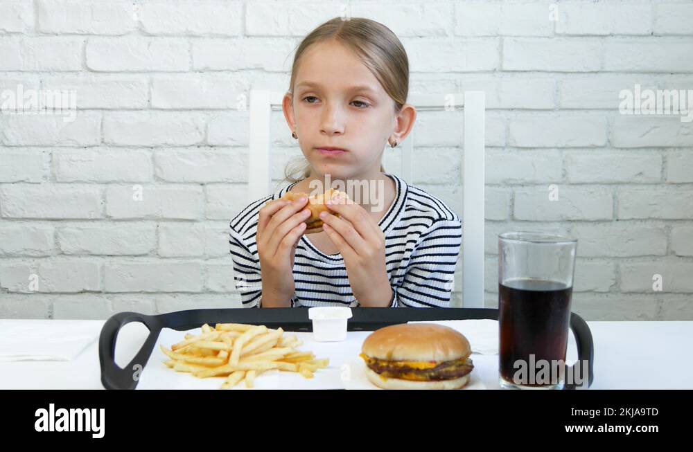 Kid Eating Fast Food, Child Eats Hamburger in Restaurant, Girl Drinking ...