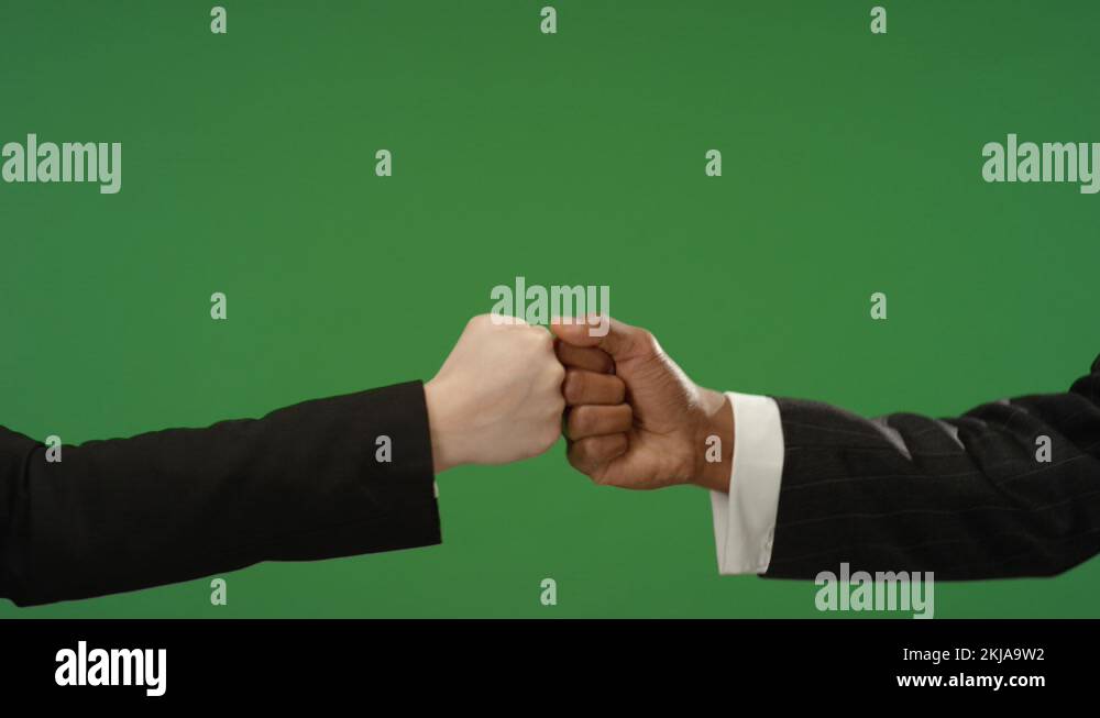 CU Colleagues in suits fist bump explosion on green screen Stock Video ...