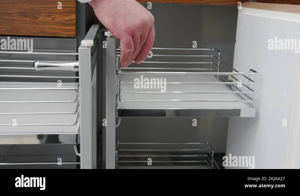 A man opens a corner cargo for the kitchen. Empty cargo in the kitchen ...