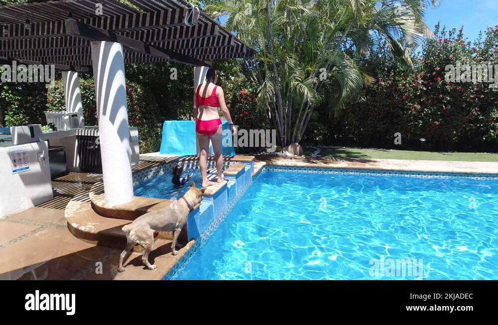LOS CABOS MEXICO-2020: Girl In Red Bikini Walking On Ledge Of Pool With ...