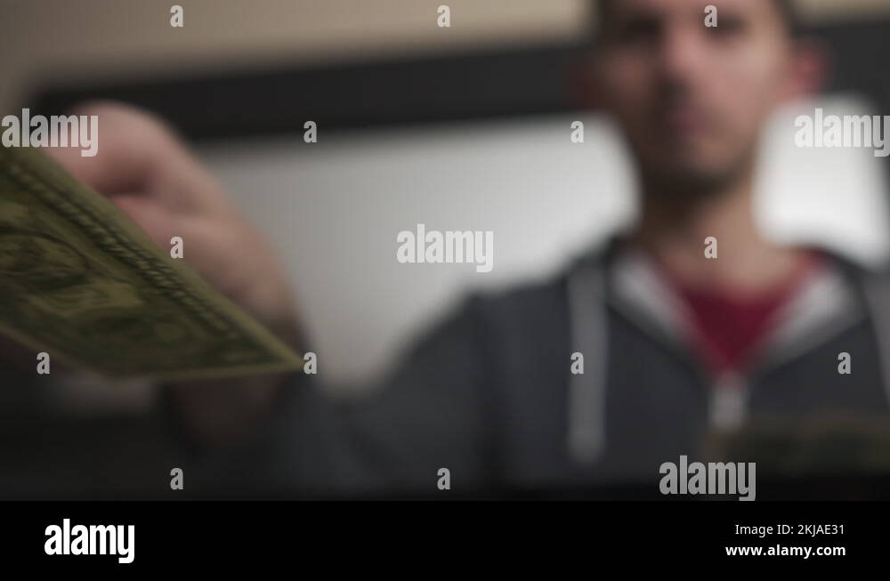Close-up 4k slow motion video of a blurry man counting american dollars ...