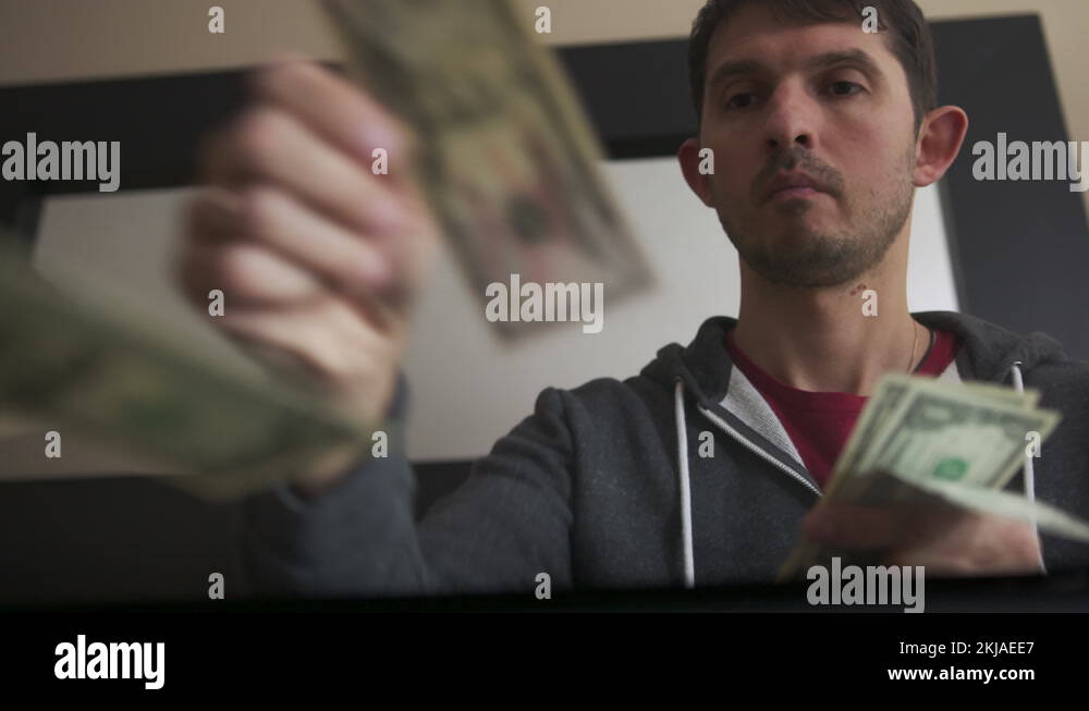 Close-up 4k slow motion video of a man counting american dollars cash ...
