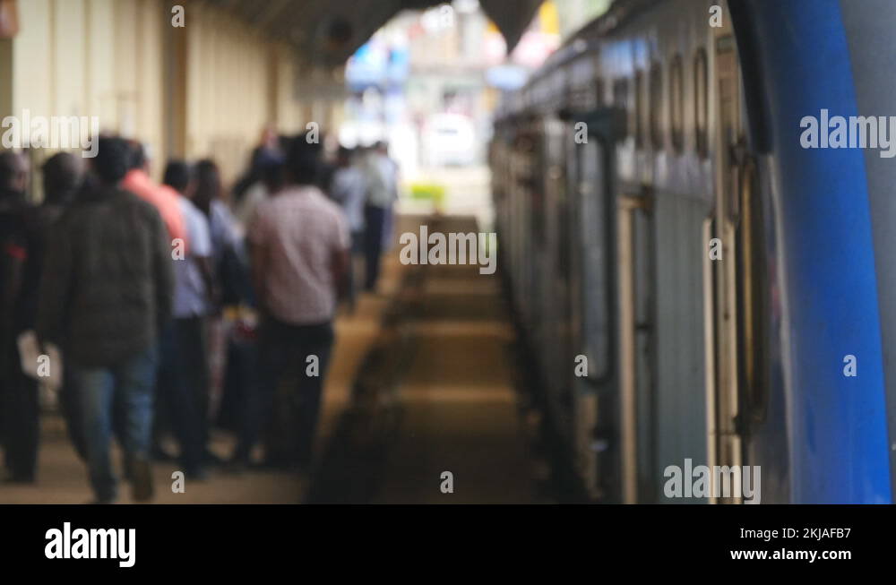 Blue passenger train leaves a station during transporting people ...
