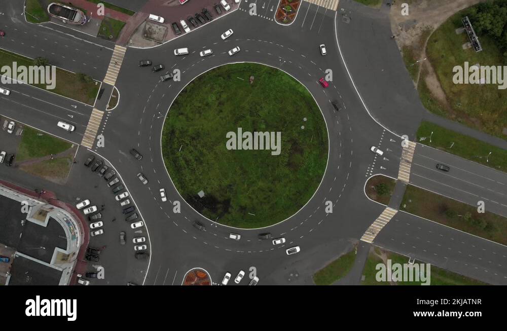Circular road top-down aerial shot. Slow traffic at peak hour in one ...