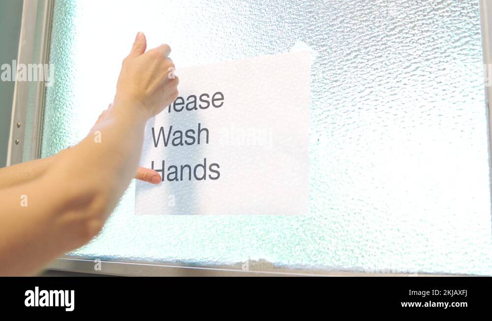 Putting up signs in building to help avoid Covid19 Coronavirus pandemic ...