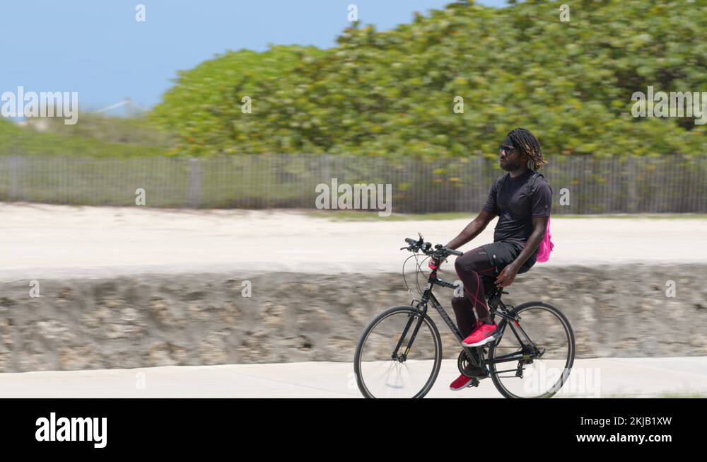Young black male riding a bike in Miami Beach African American healthy ...
