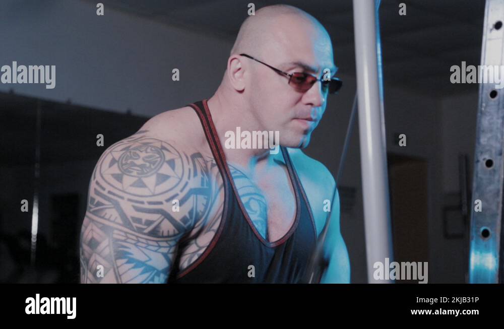 Professional bodybuilder trains triceps on a block simulator in a ...