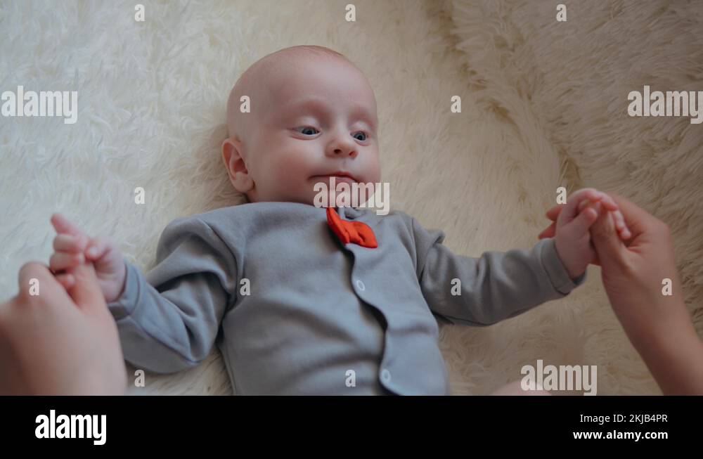 Mom Does Hand Exercises With Her Little Baby. Child Development And ...