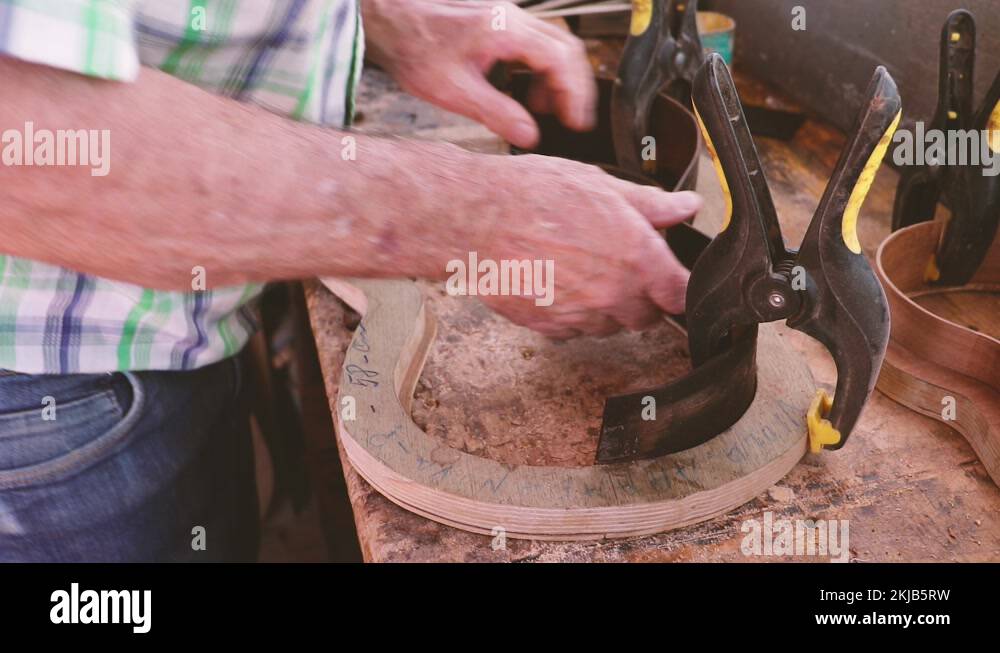 Luthier's Hands Shaping An Acoustic Guitar Body Frame In A Guitar Stock ...