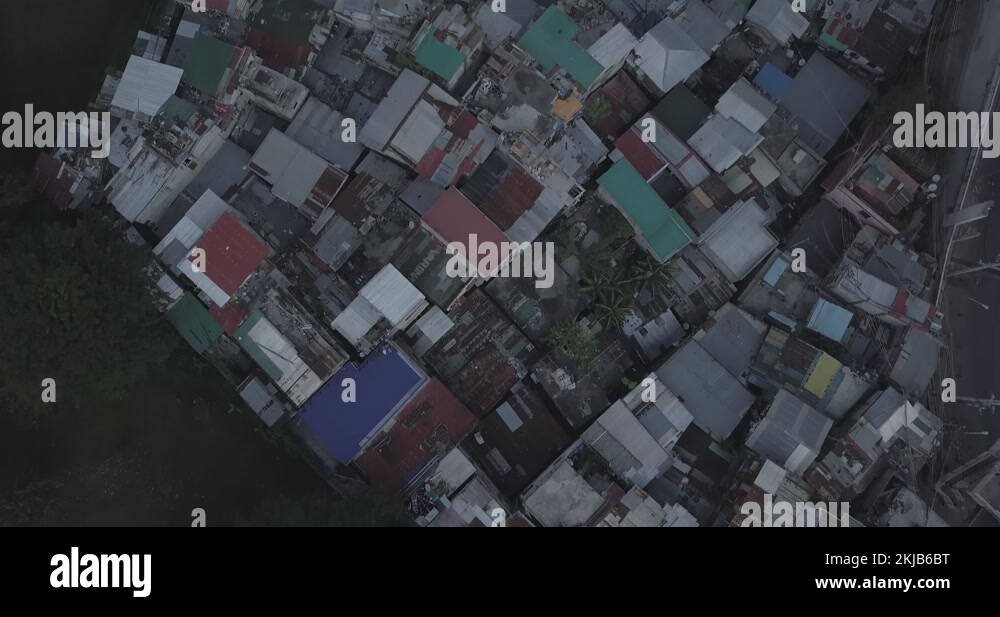 Ungraded, Contrast aerial flight of poor area, Tilt up to reveal rich ...