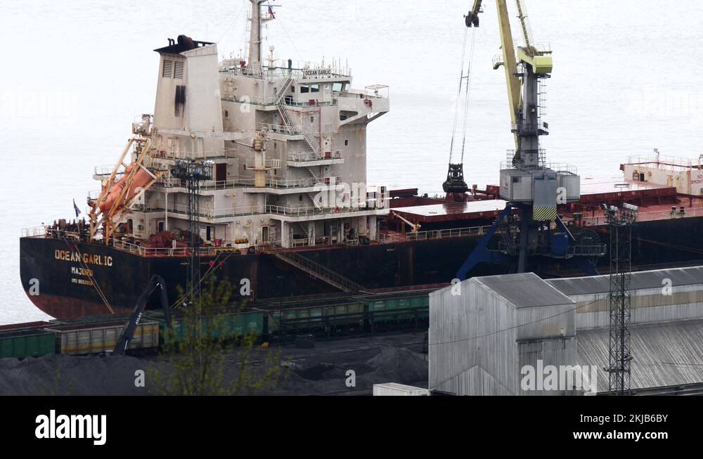 Crane load a big ship with coal in the Murmansk commercial sea port ...