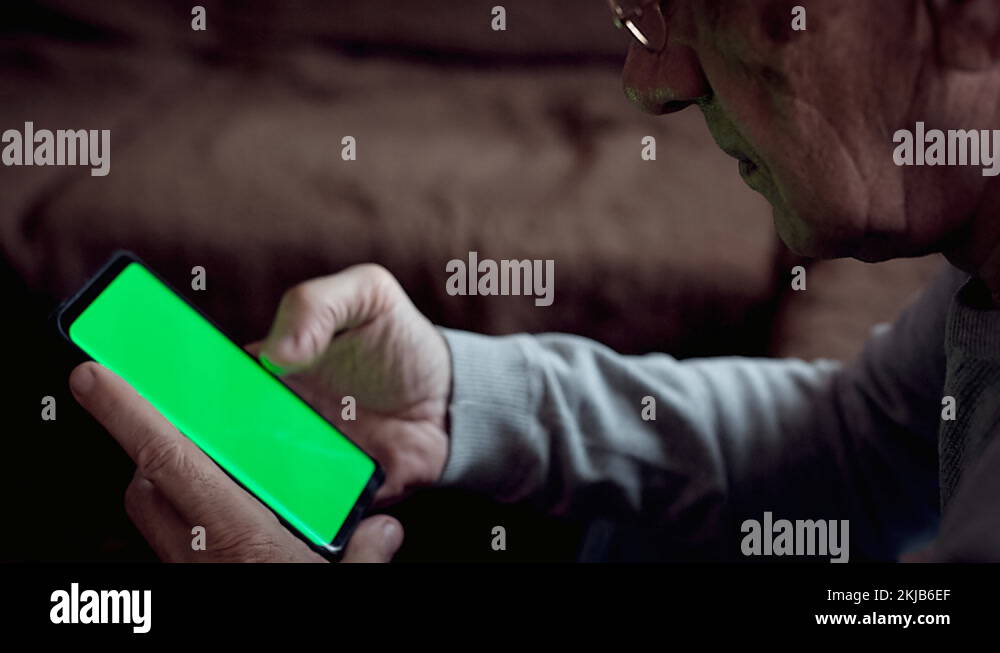 using smart phone with green screen. hands scrolling pages, tapping on ...