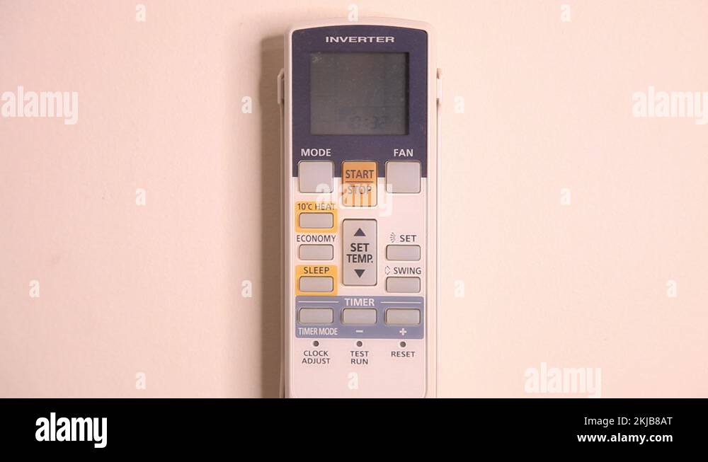 Man finger is pushing buttons using an air conditioner remote control ...