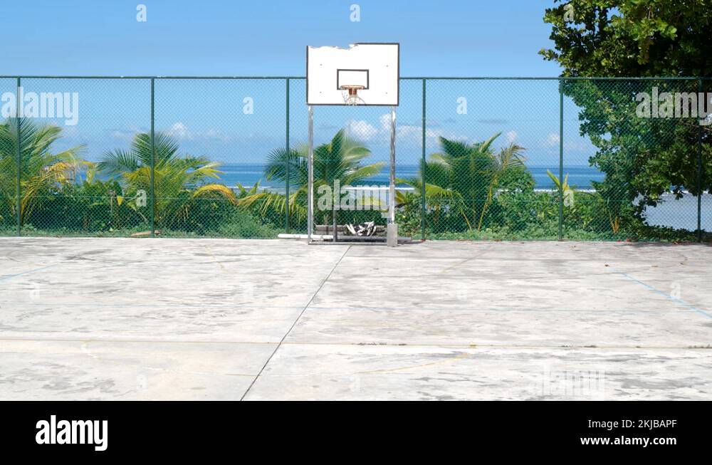 Derelict basketball court on a tropical island, waves and beautiful ...