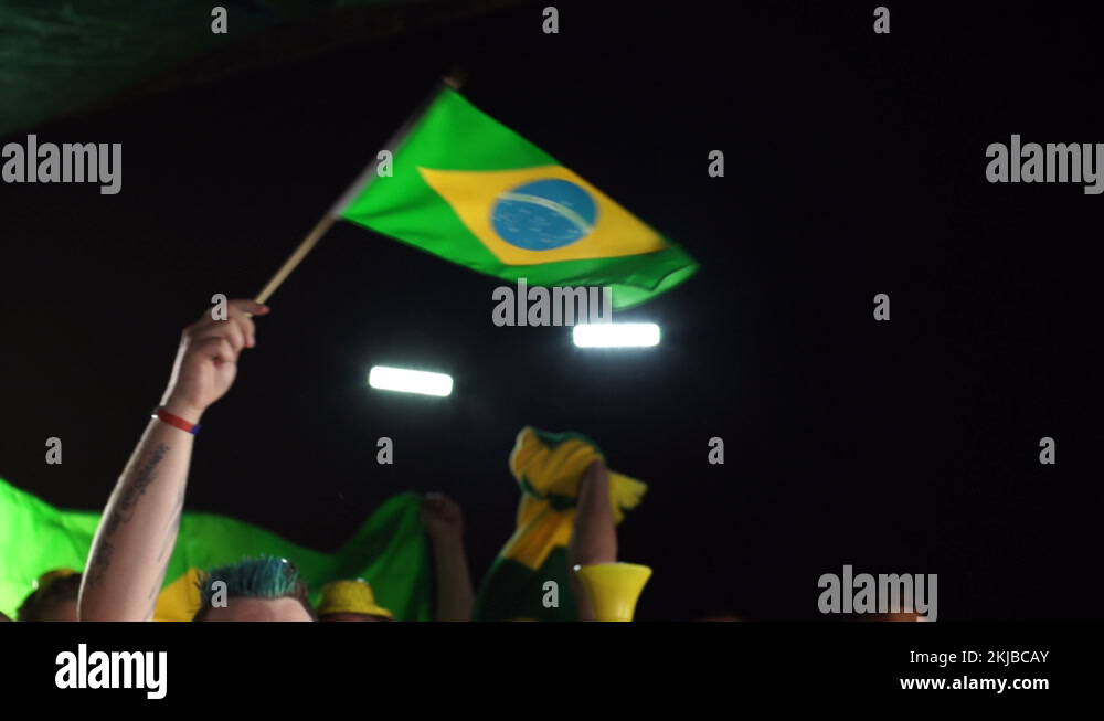 Brazil fans wave brazilian flags at a Football / Soccer match. Green ...