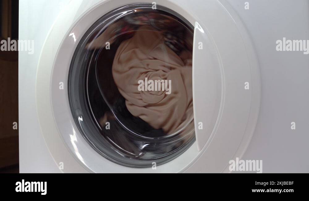Dirty things rotate in the washing machine, side view. Washing things ...