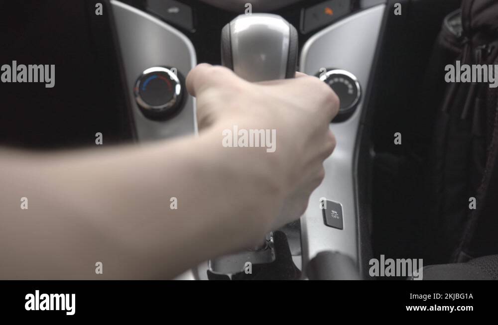 Driver's Hand On The Car's Center Console Switching To Drive - close up ...