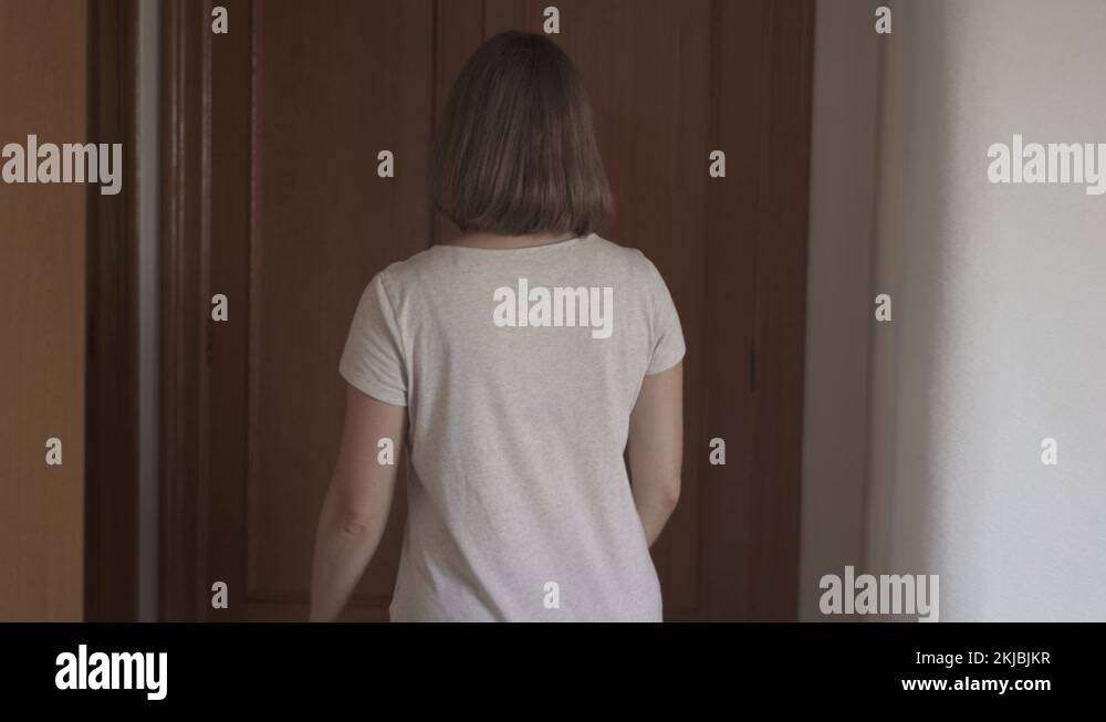 Back view of woman opening wardrobe and choosing what to wear Stock ...