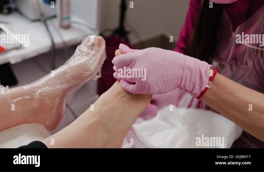 Pedicure master cleans the legs of a woman Stock Video Footage - Alamy