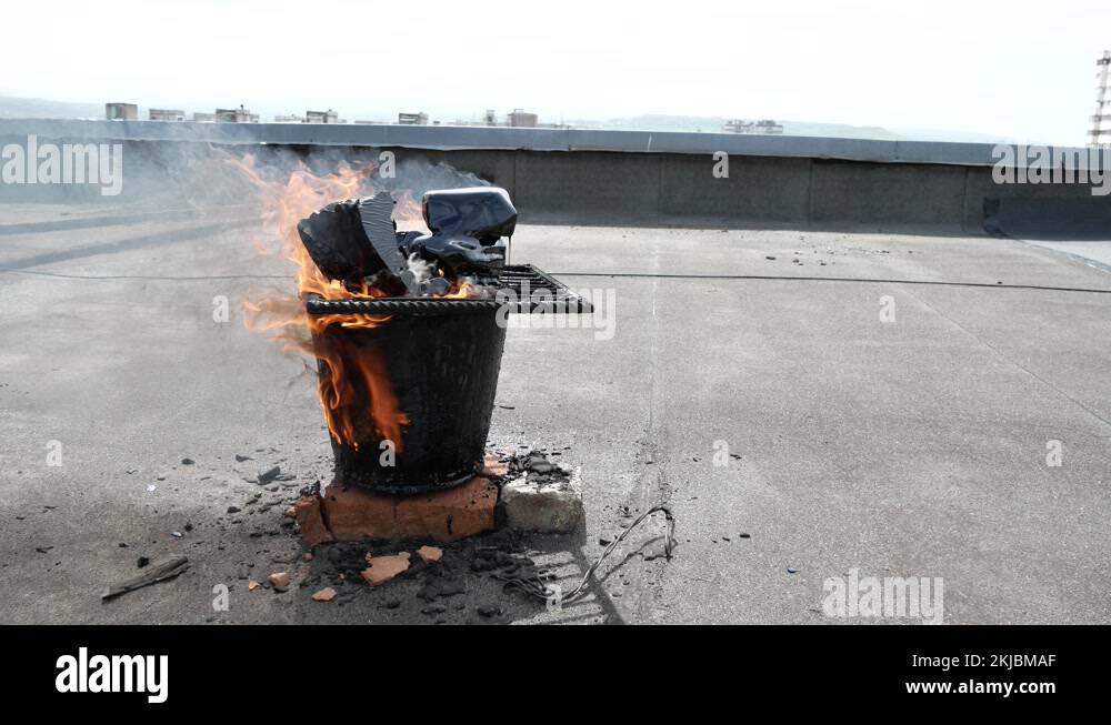 bucket boiling tar, resin, bricks. melted bitumen in bucket burner ...