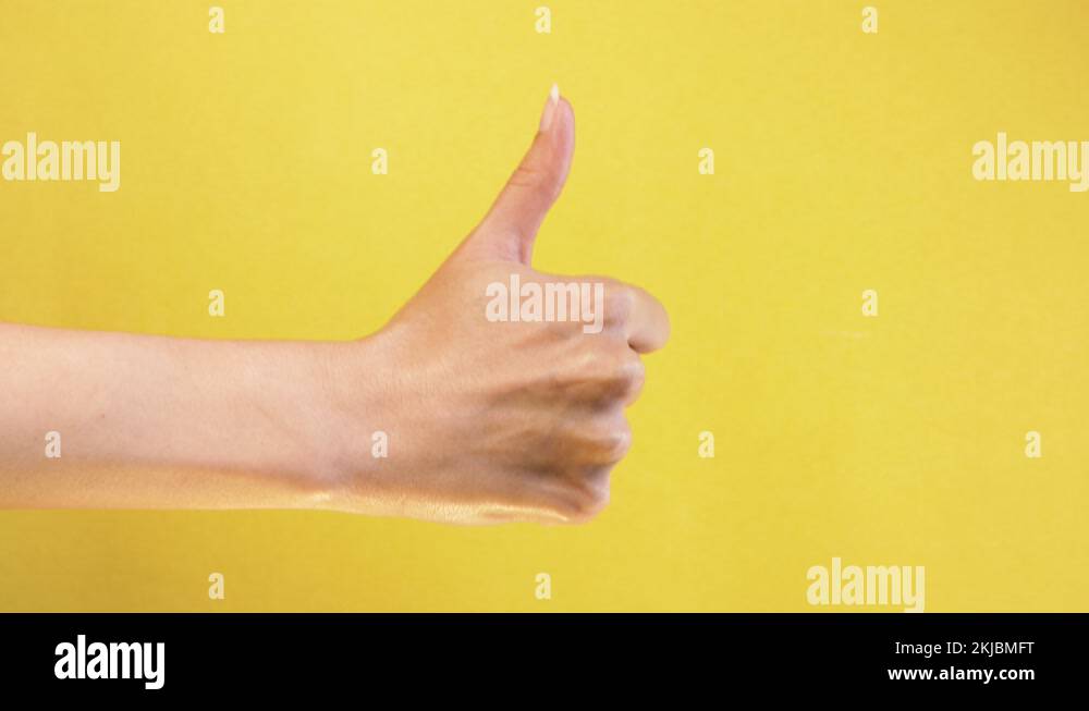 Female hand show thumbs up gesture. Woman rise OK good sign closeup ...