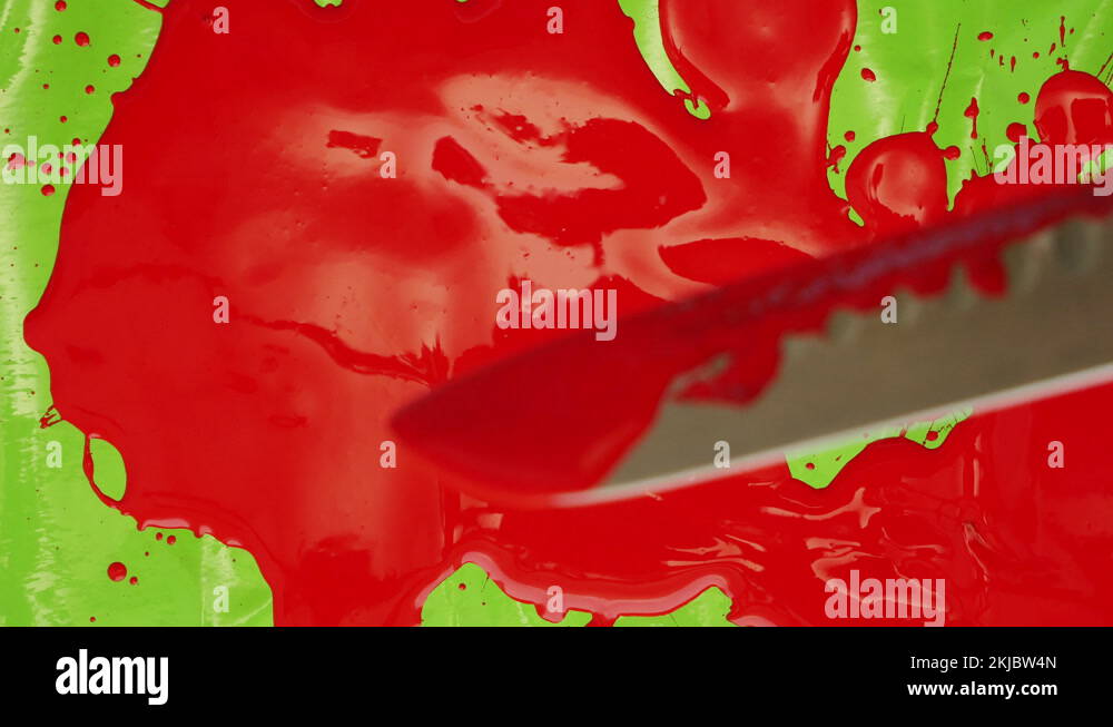 Carving knife in a pool of blood on a green background. Crime scene ...