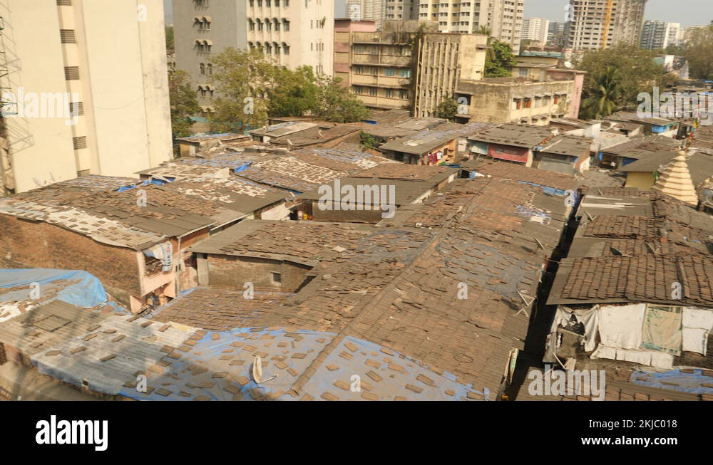 Slums and towers under construction.Top pan shot of roofs. Mumbai ...
