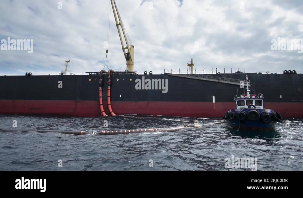 Loading an Oil Tanker. Oil ship is transferring supply to the cargo ...