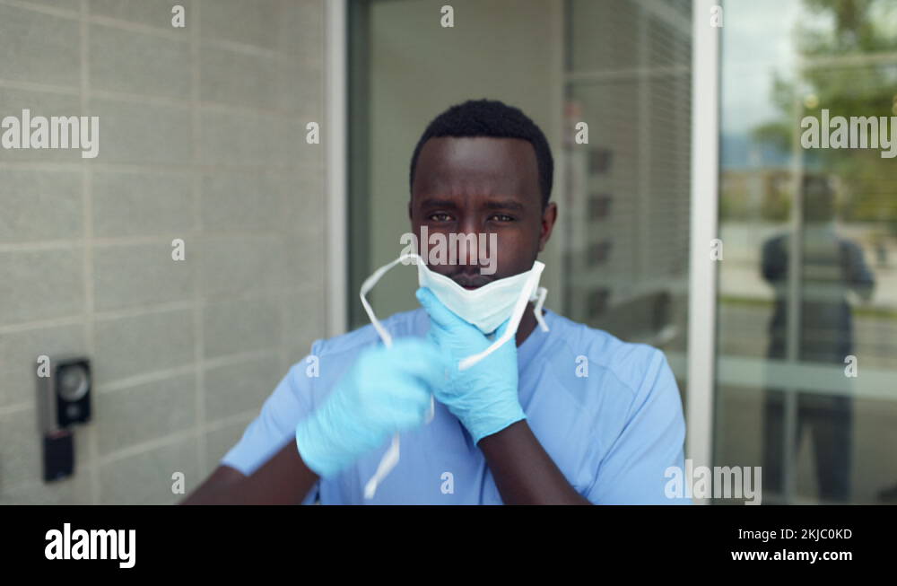 African American black man nurse doctor wearing PPE adjusting blue ...