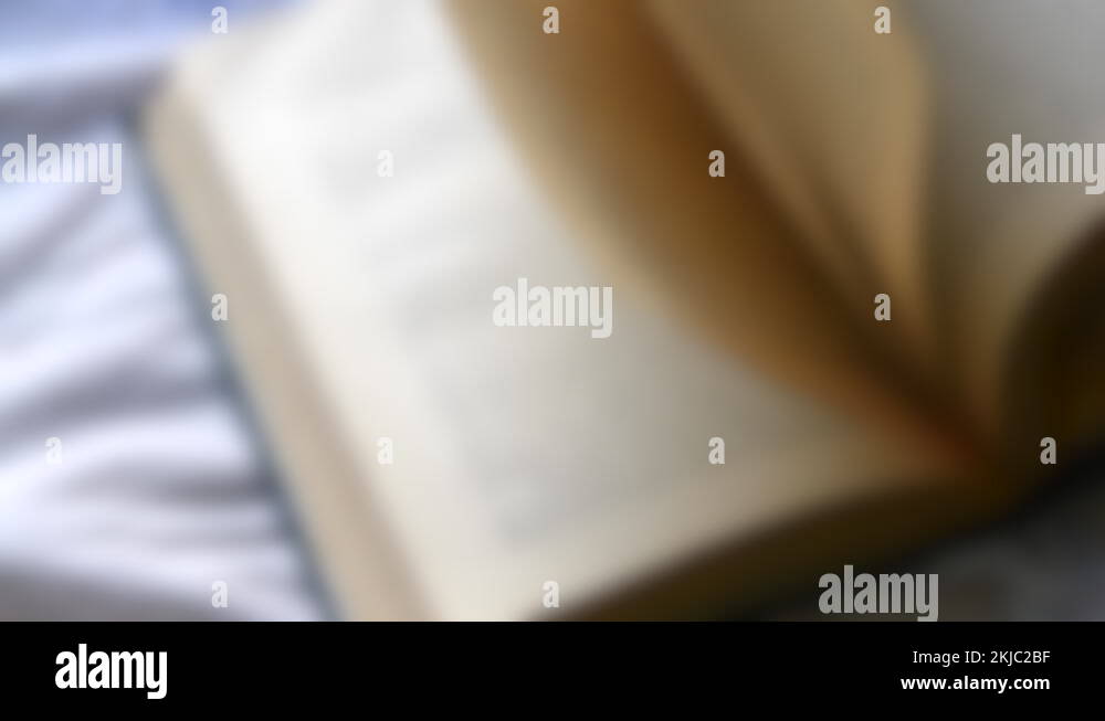 Turn over sheets an old vintage book close-up lying on a flat surface ...