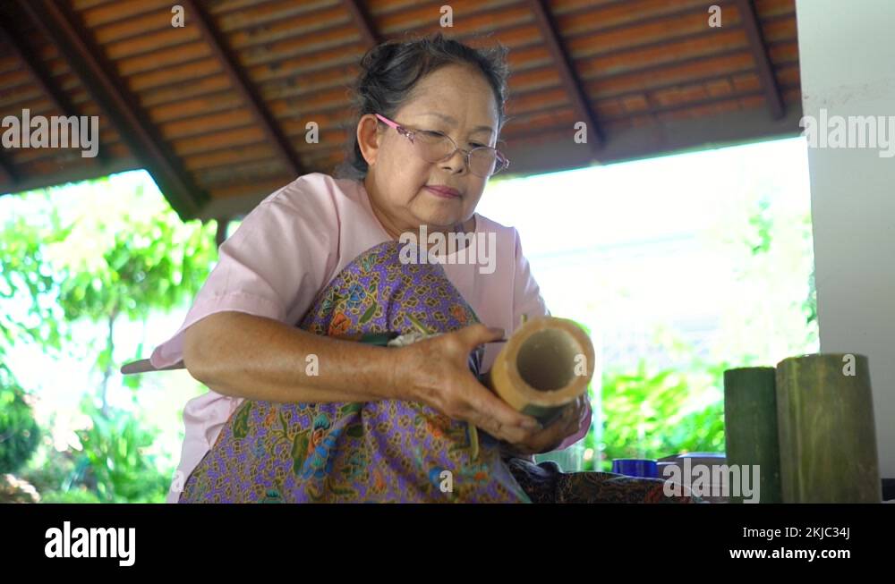 Old Woman Scraping The Skin Of A Bamboo Stalk With A Sharp Bolo Knife ...