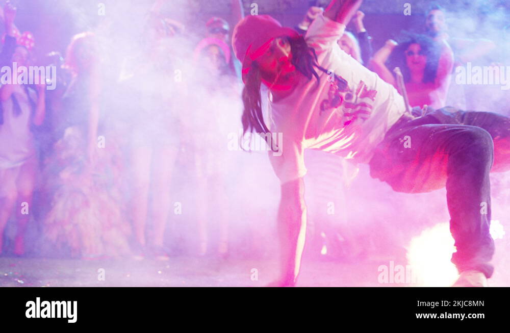 Young people partying . Stylish Boy dancing break dance with fire on ...